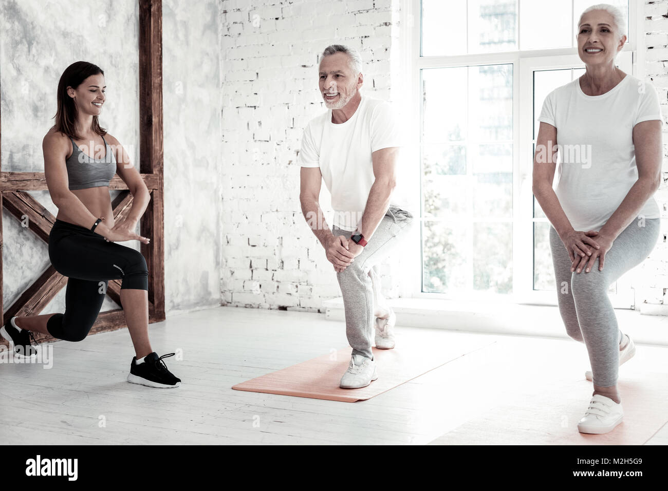 Happy retired people training and smiling at fitness club Stock Photo ...