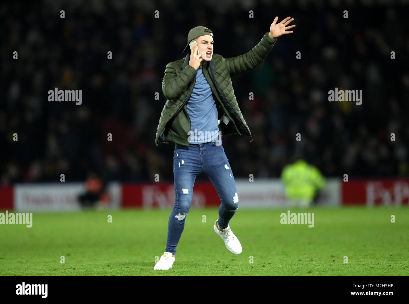 A pitch invader on his mobile phone on the pitch Stock Photo - Alamy