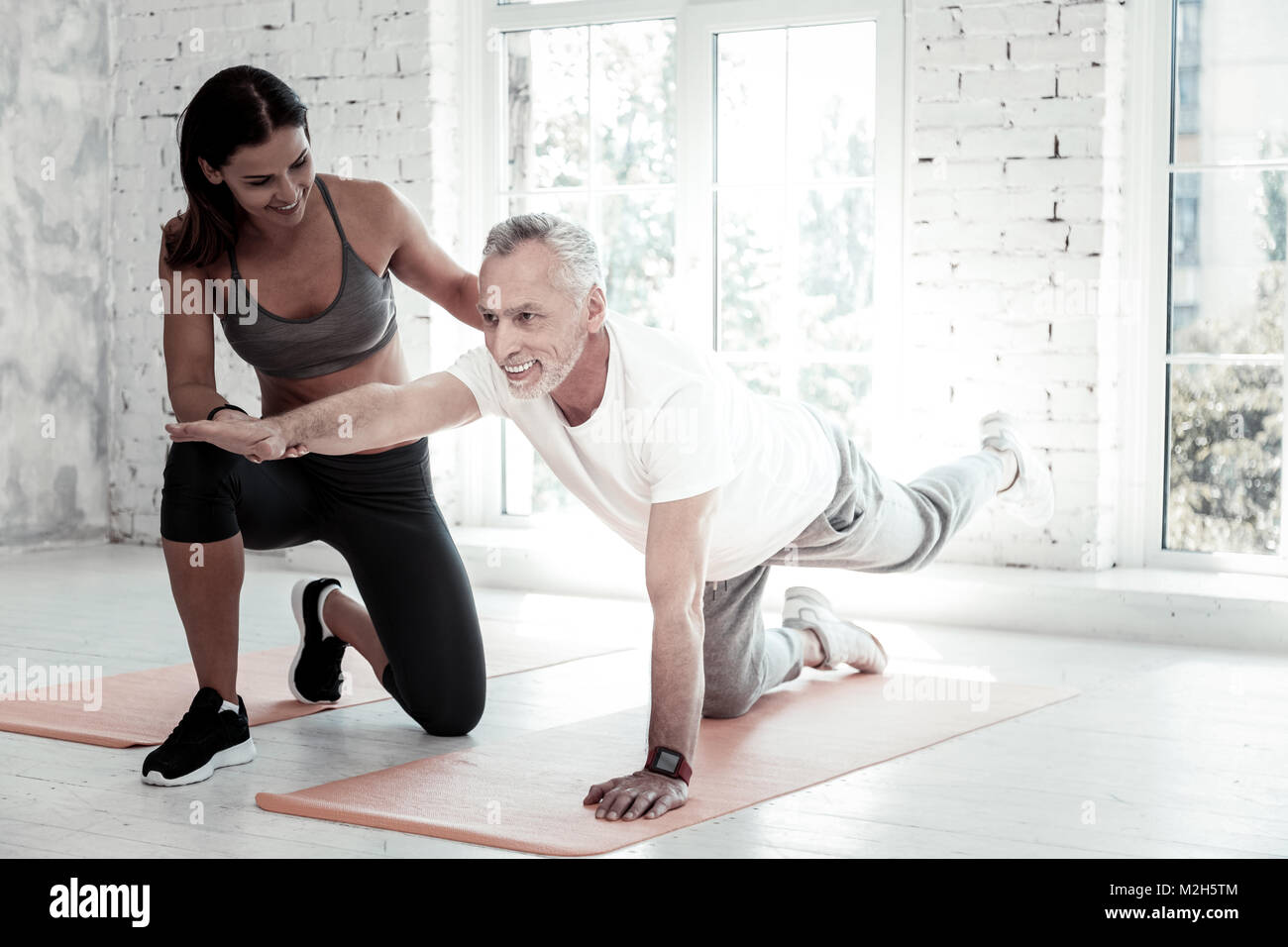Joyful retired man exercising in gym Stock Photo - Alamy