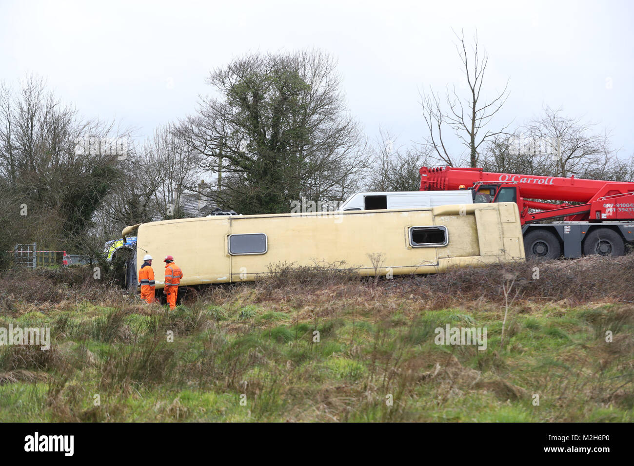 Vehicle recovery specialists at the scene where a school bus crashed in ...