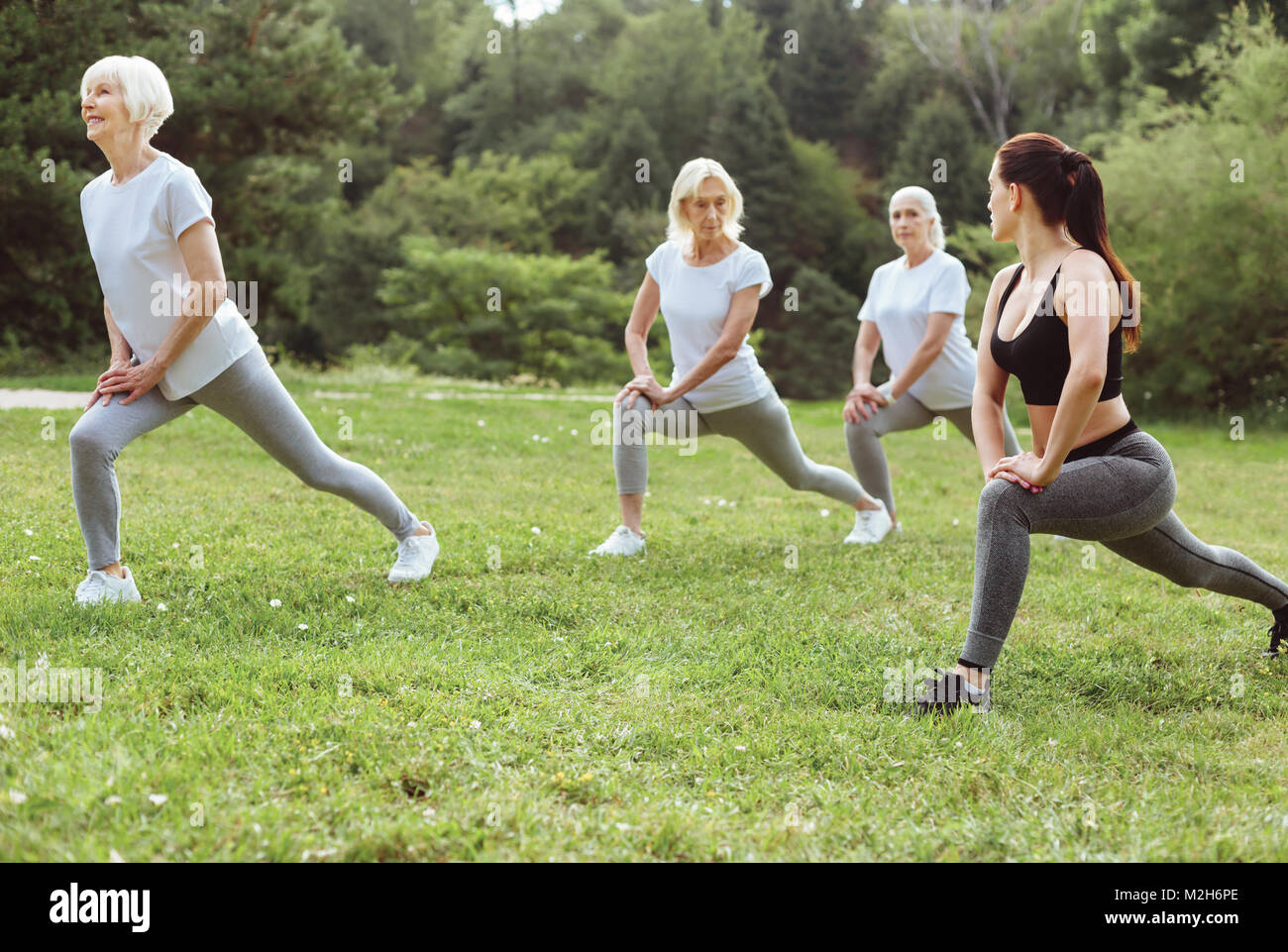 Happy active women looking at their coach Stock Photo - Alamy