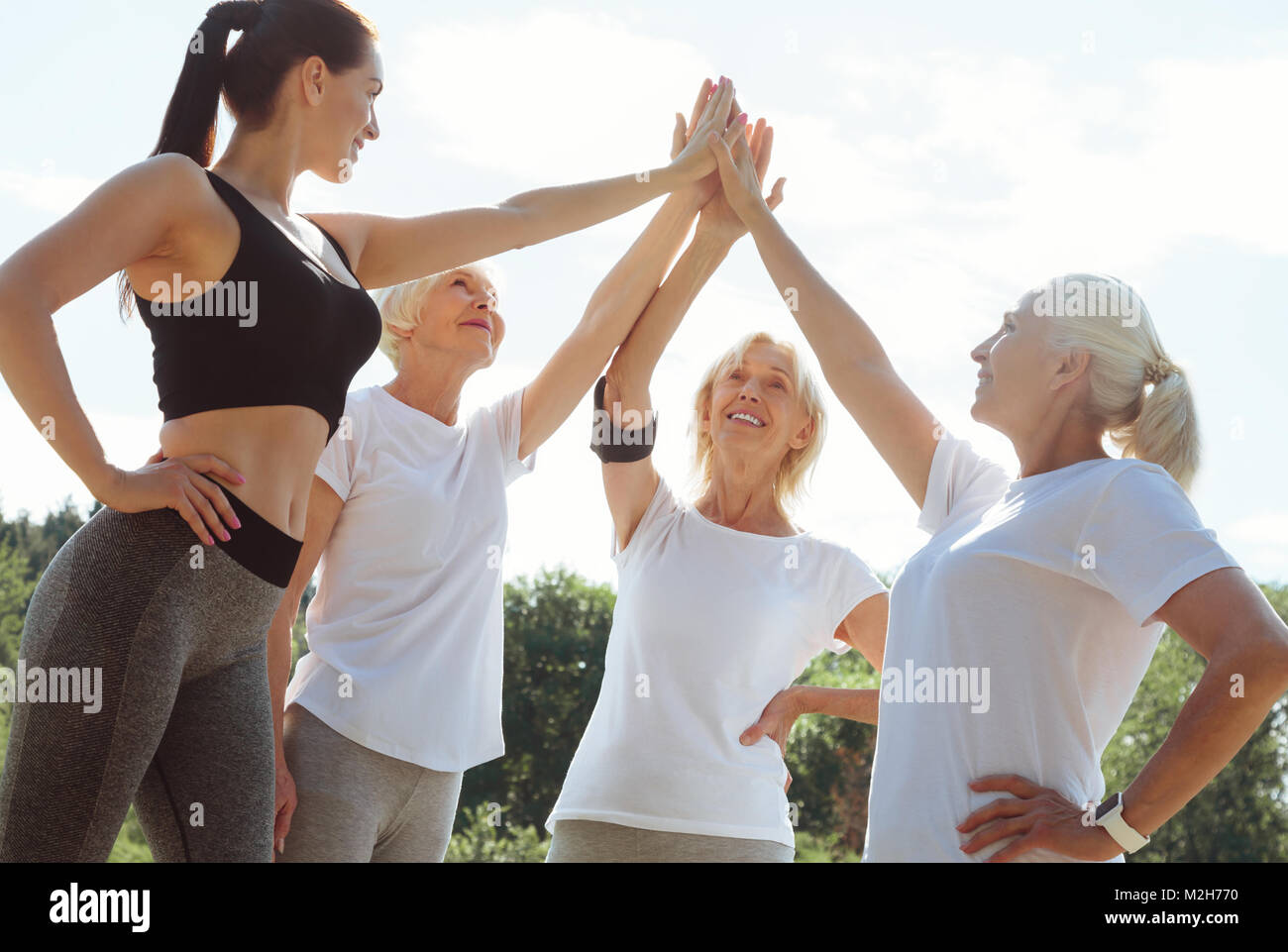 Nice happy women giving high five Stock Photo - Alamy