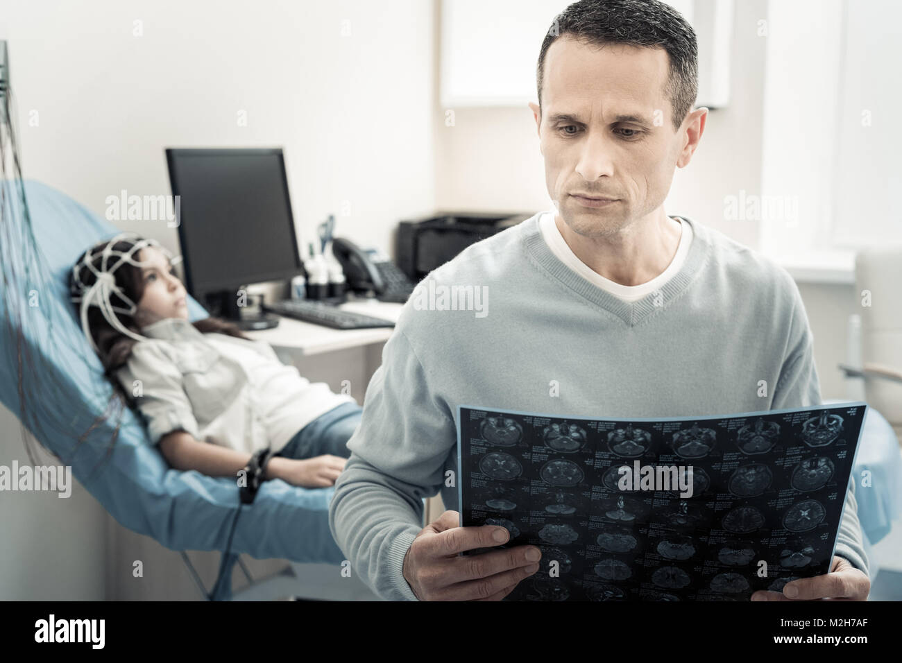 Serious handsome man studying an X ray scan Stock Photo - Alamy