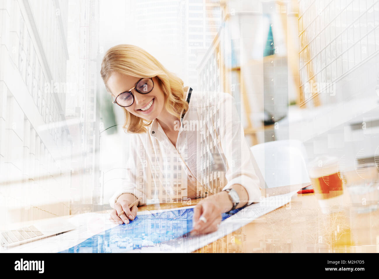 Cheerful designer dedicated to work Stock Photo - Alamy