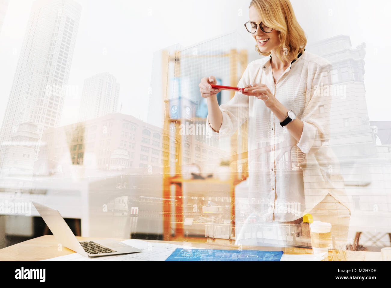 Cheerful engineer making a photo of her sketch Stock Photo - Alamy