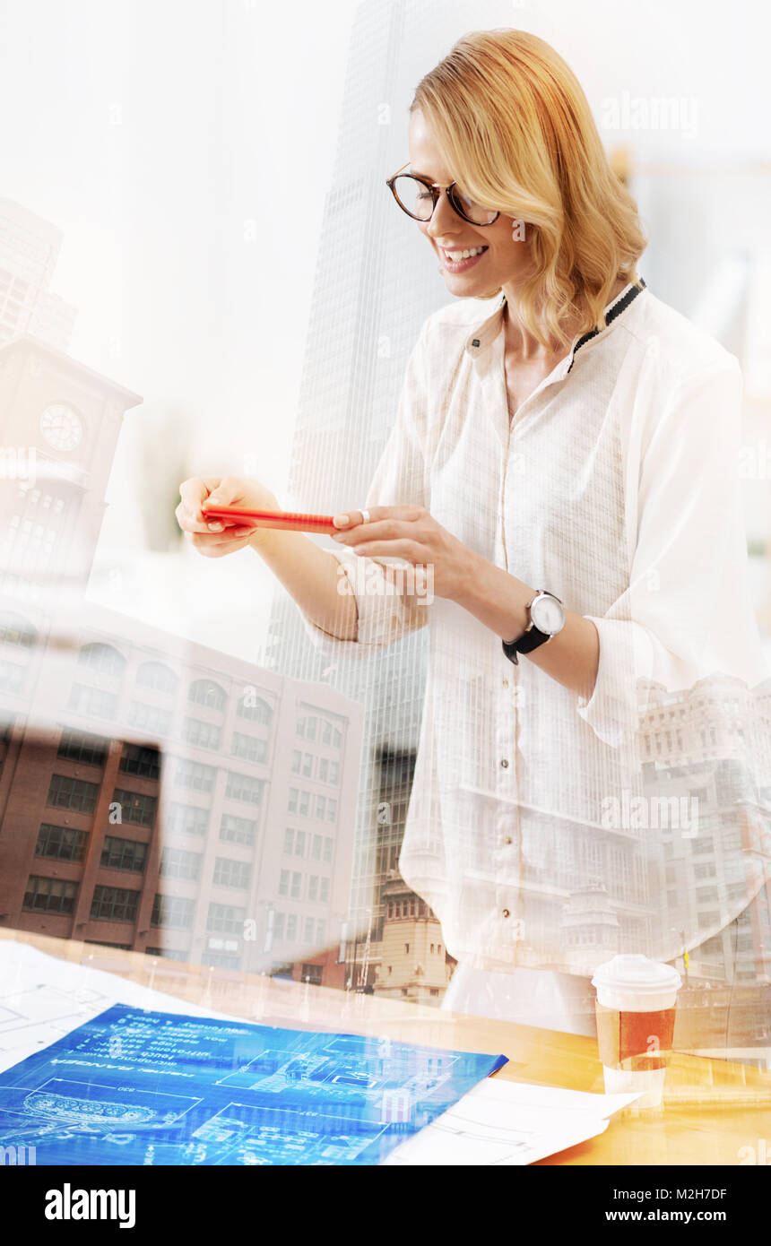 Pretty designer photographing her work Stock Photo - Alamy