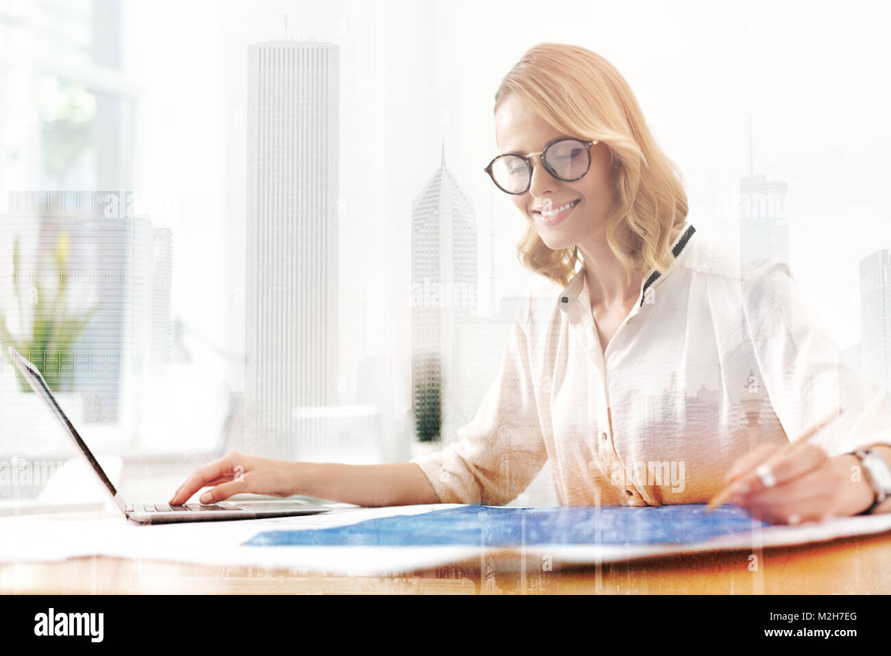 Satisfied engineer working at the table Stock Photo - Alamy