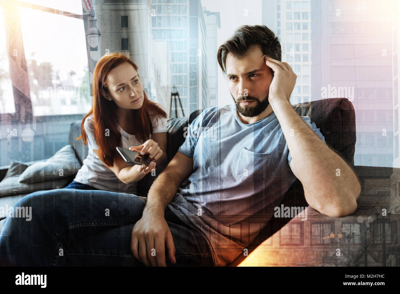 Jealous woman showing her boyfriend compromising material in his phone ...