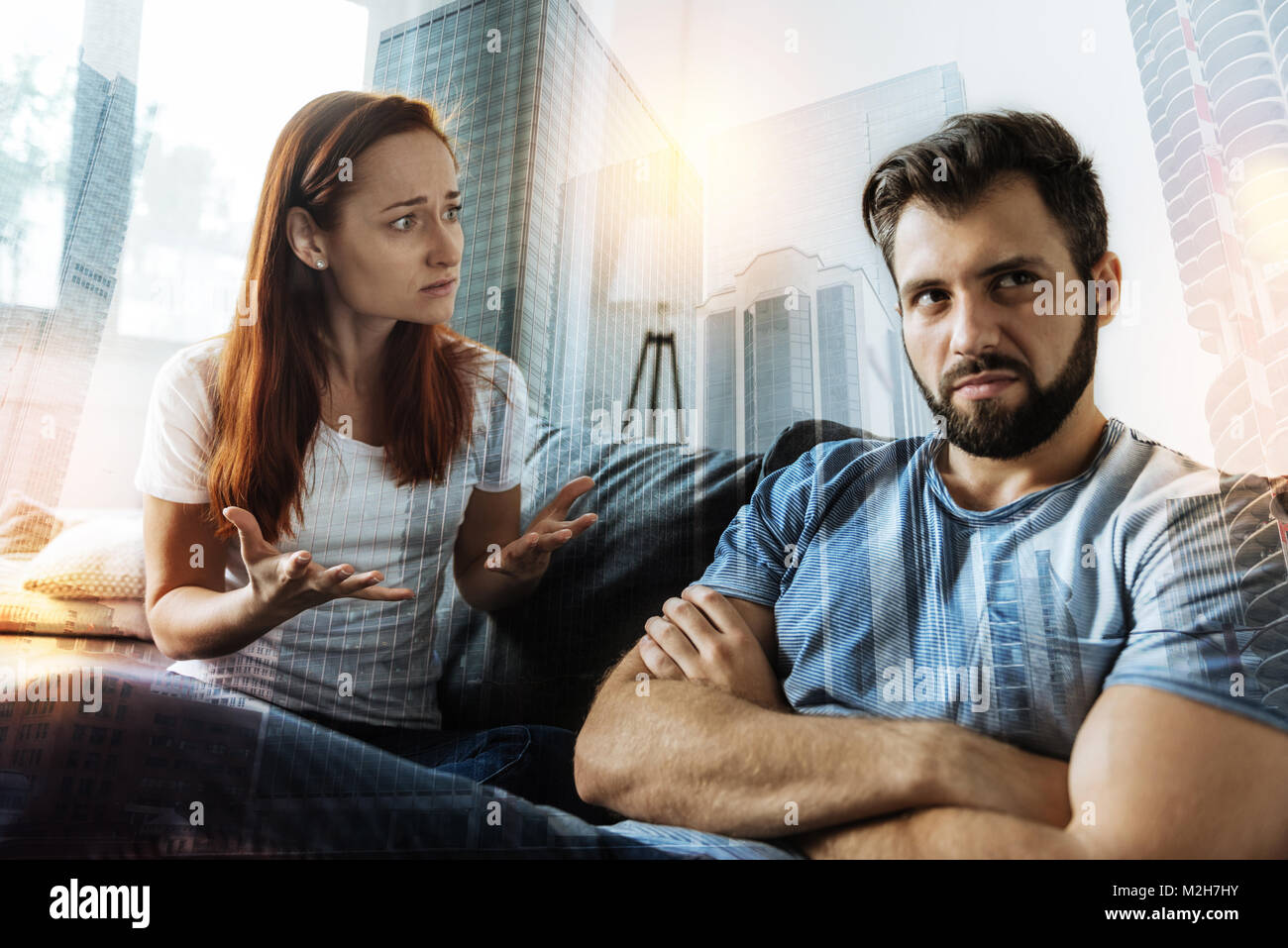 Emotional woman using gestures while talking to her indifferent ...