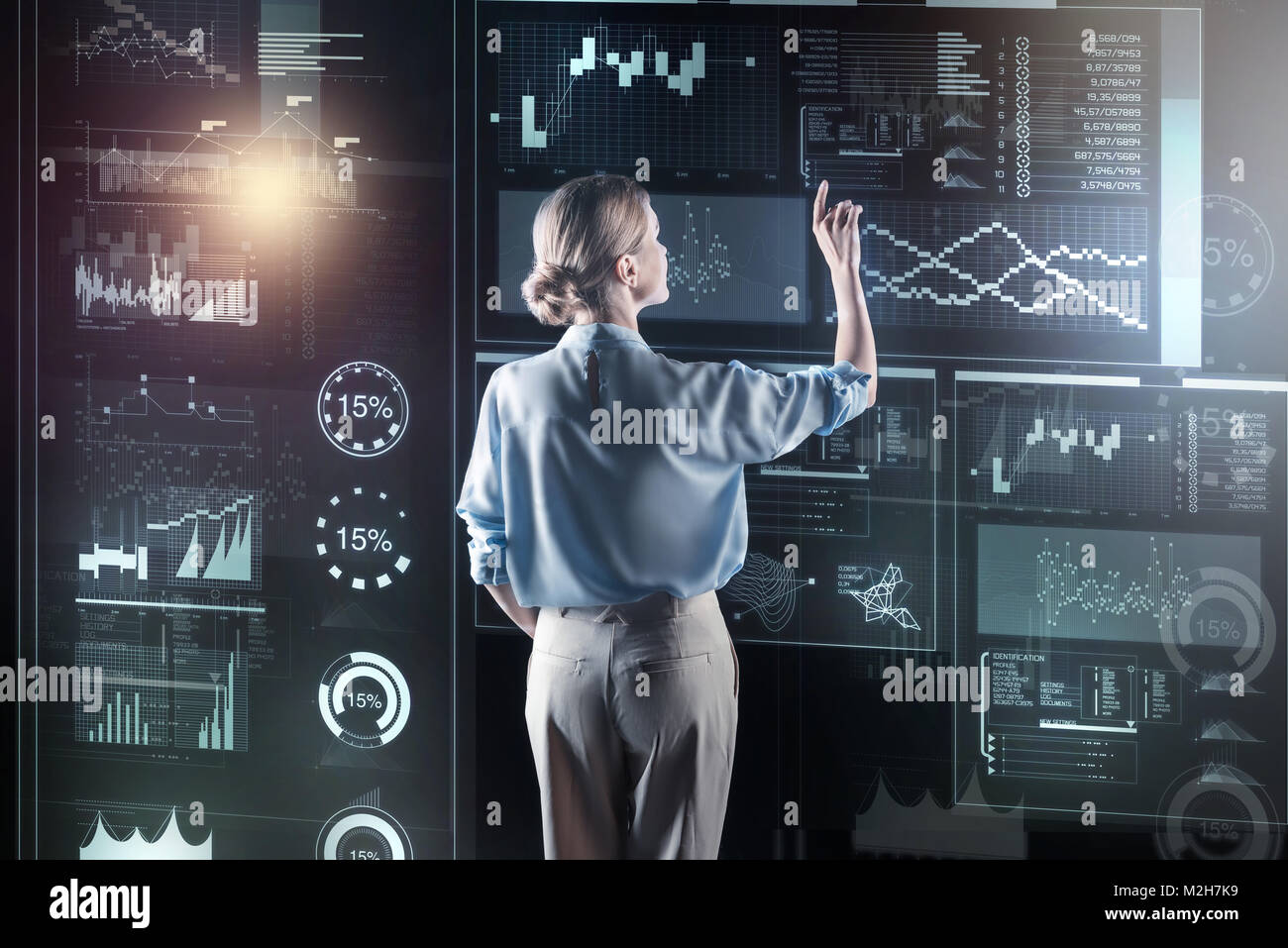 Smart employee touching the transparent screen while working Stock ...