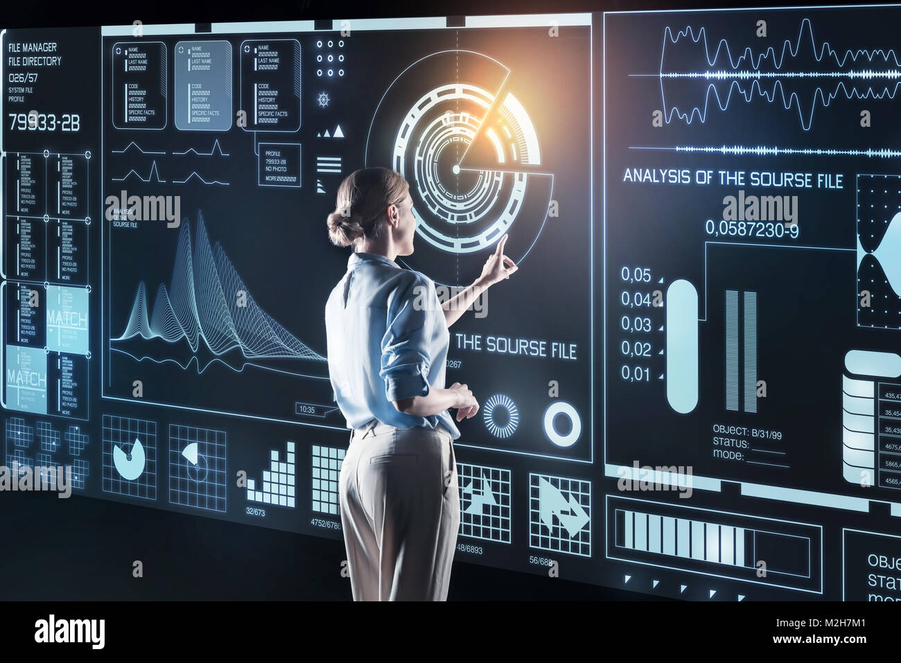 Experienced programmer looking elegant and standing in front of a giant ...