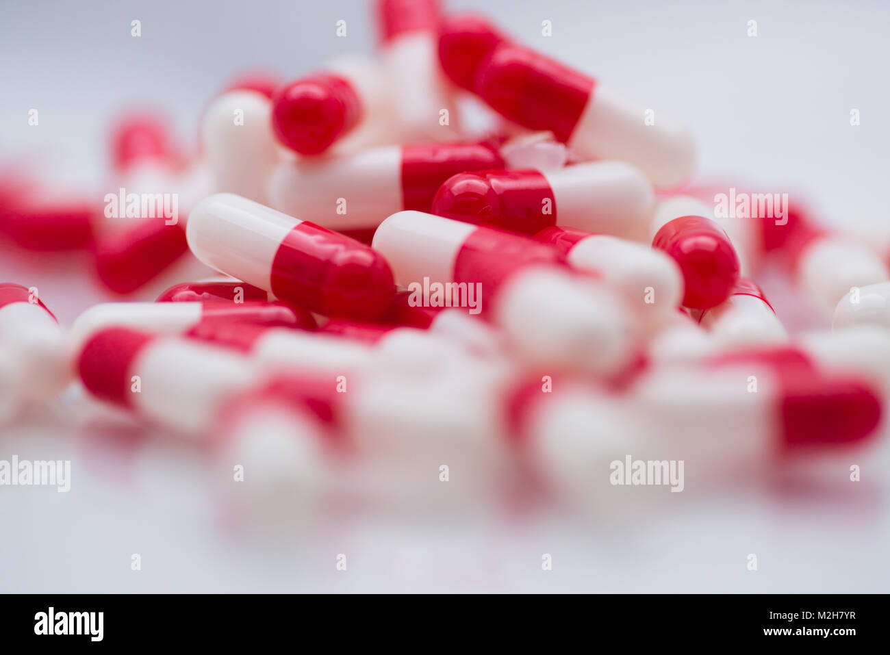 Close up of red and white capsule pills, pharmaceuticals, medicine ...