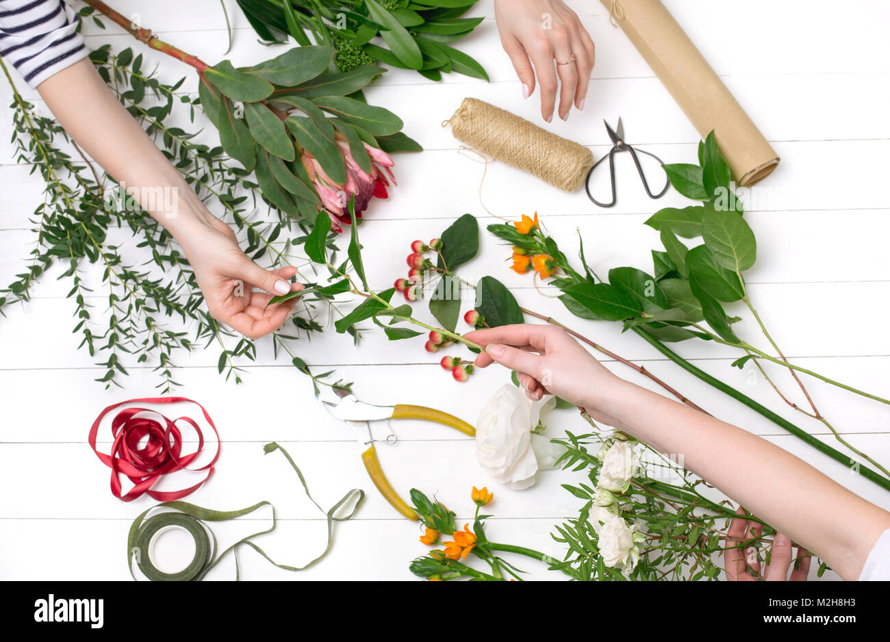 Female florist making beautiful bouquet at flower shop Stock Photo - Alamy