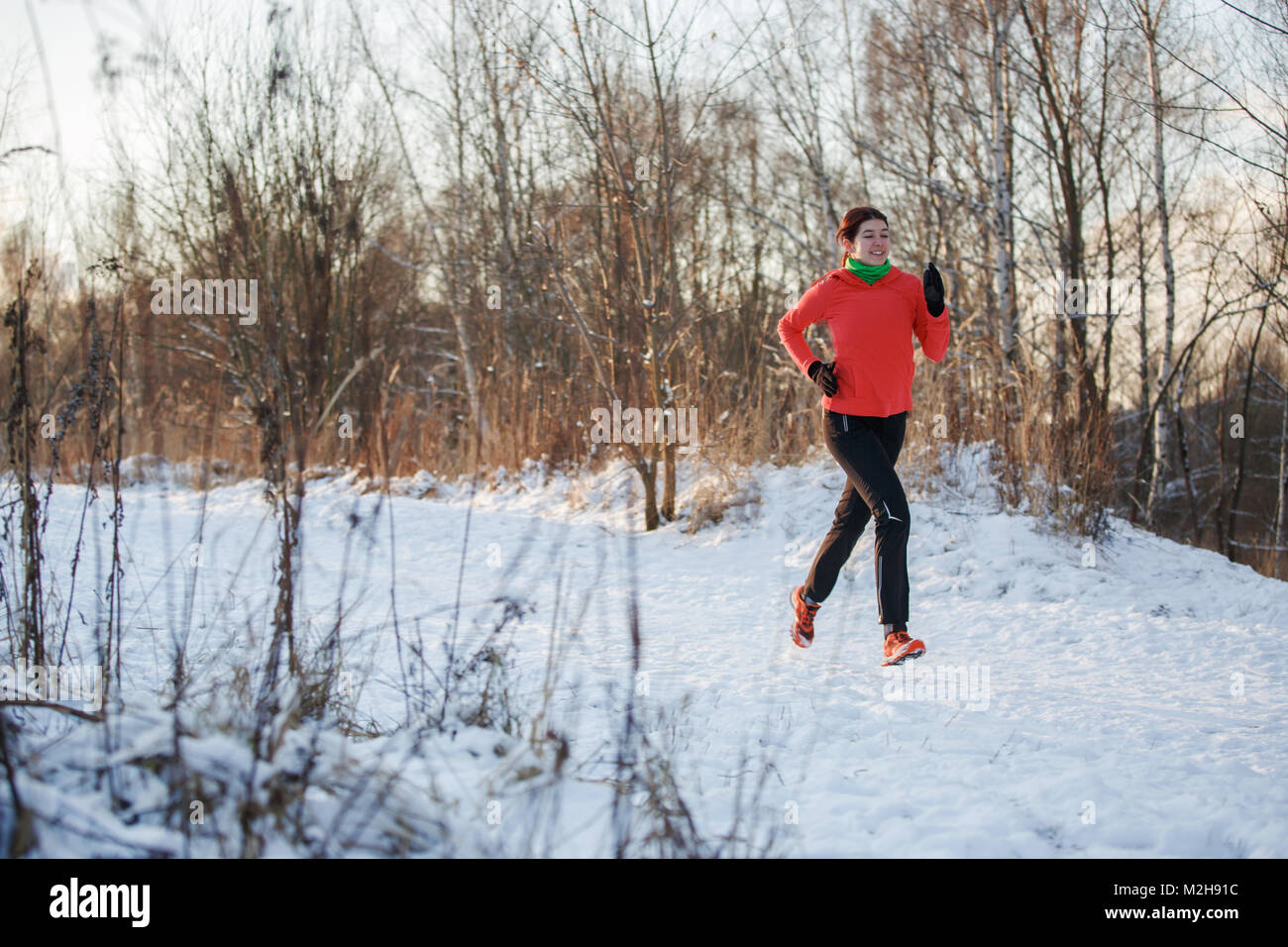 Female athlete running in winter park on morning run Stock Photo - Alamy