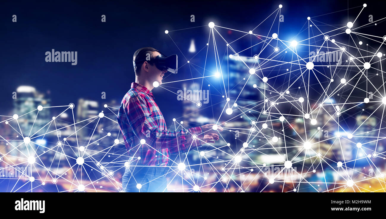 Guy wearing checked shirt and virtual mask reaching hand to feel his ...