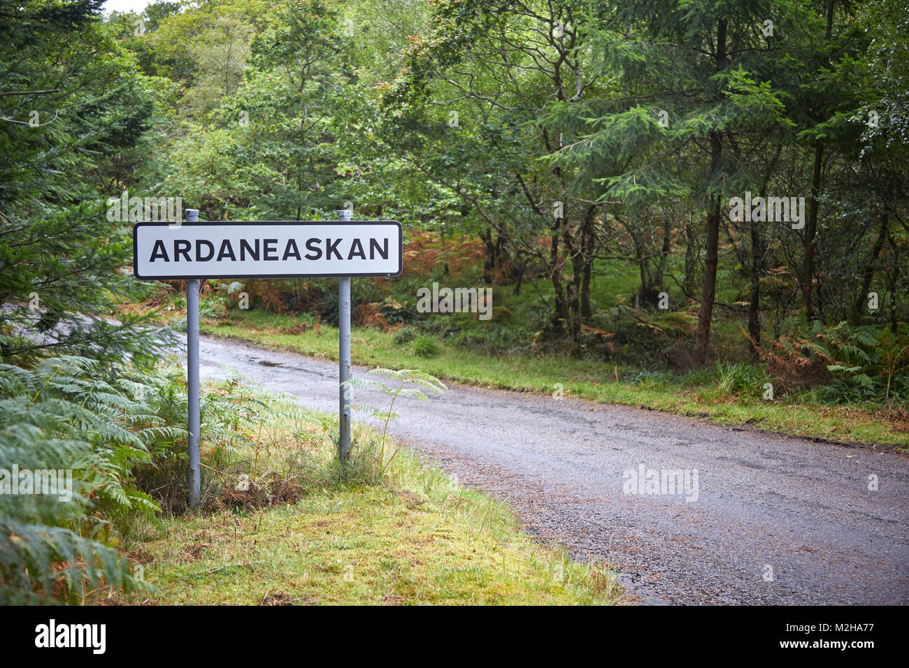 Roadside sign for village of Ardaneaskan on single track forestry road ...