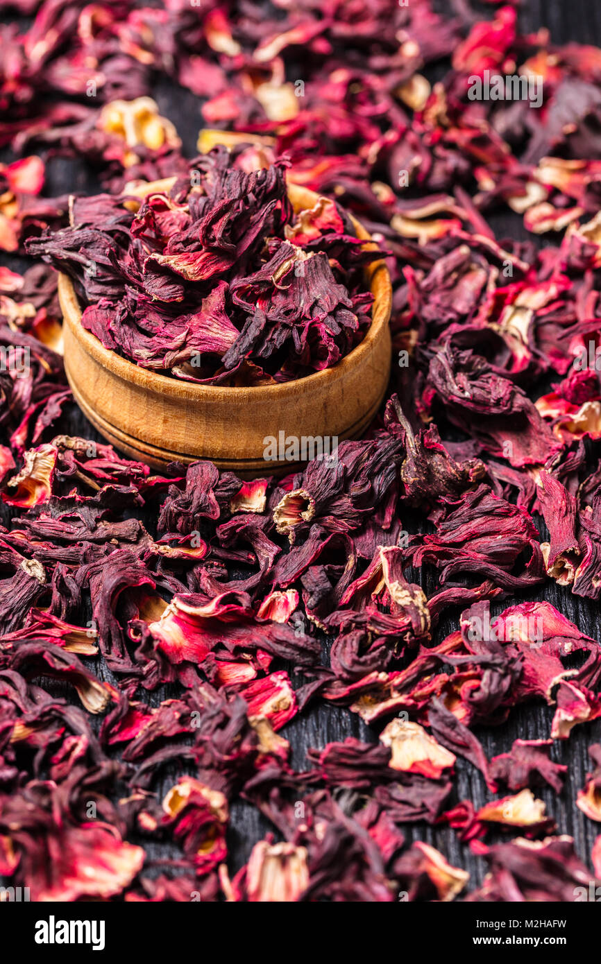dry red karkade tea in a wooden bowl Stock Photo - Alamy