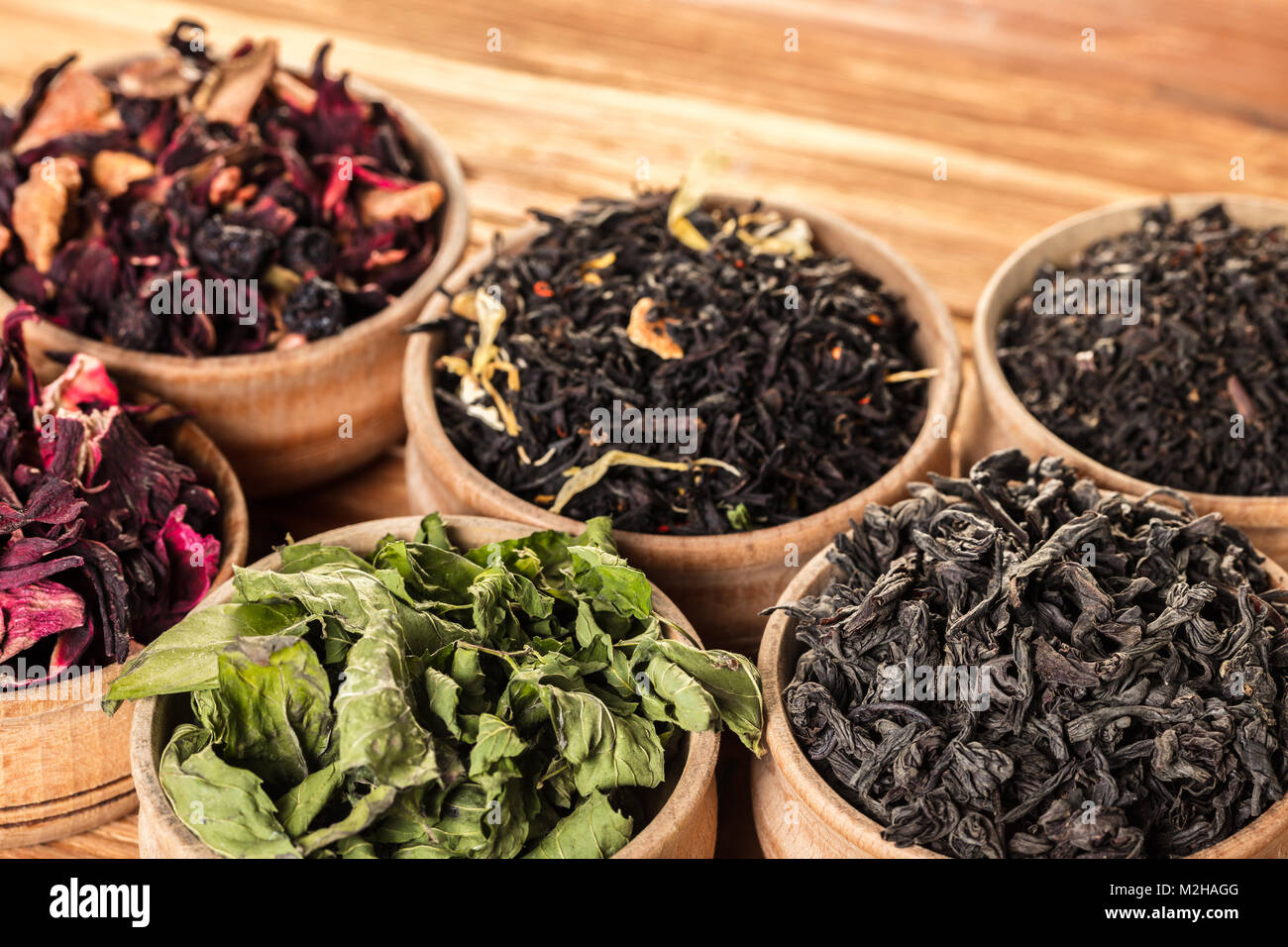 variety of dry teas in wooden bowls Stock Photo - Alamy