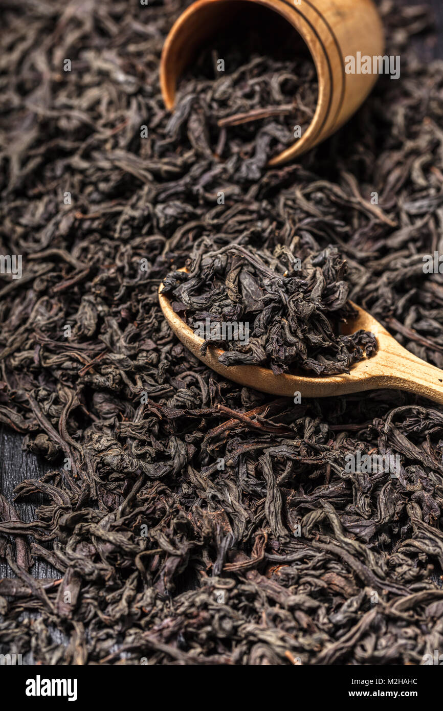 dry black large leaf tea in a wooden bowl Stock Photo - Alamy