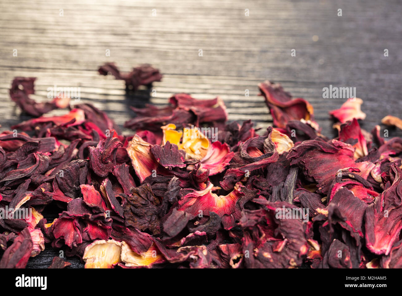 dry karkade tea on a wooden black background Stock Photo - Alamy