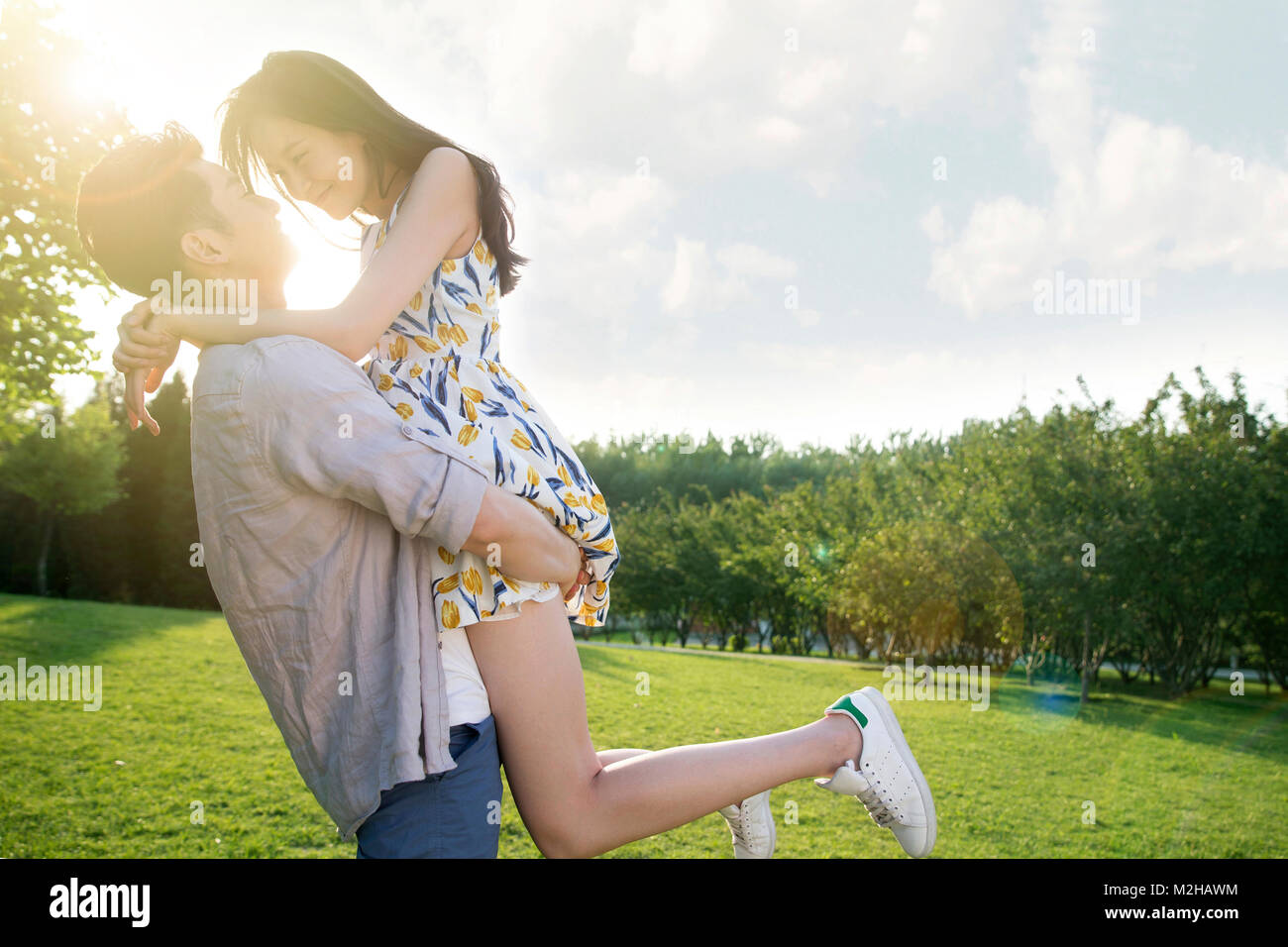 Happy lovers play outdoors Stock Photo - Alamy