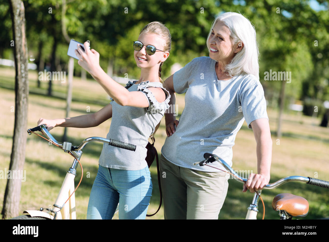 Joyful positive girl taking a selfie Stock Photo - Alamy