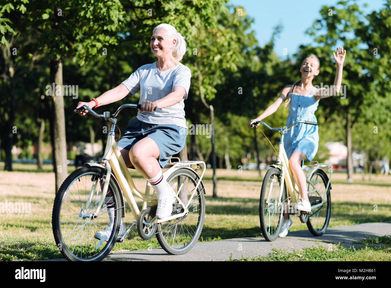 Delighted elderly woman riding a bike Stock Photo - Alamy