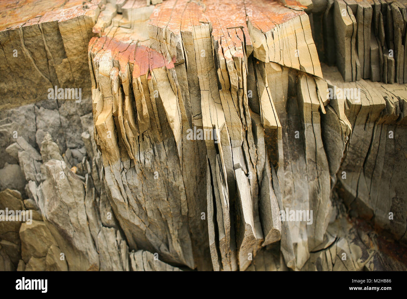 Large block grey mountain slate with vertical layers Stock Photo - Alamy