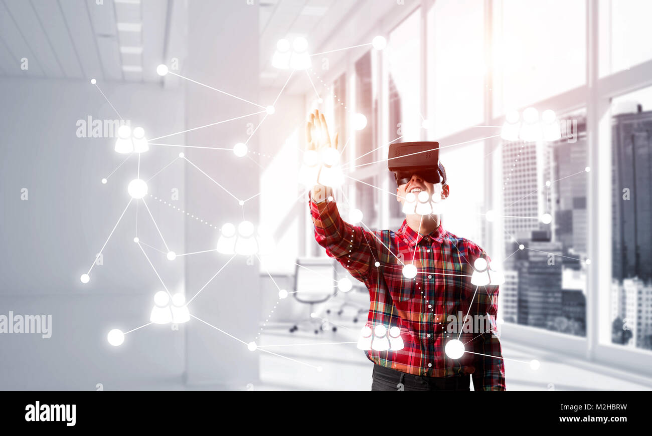 Guy wearing checked shirt and virtual mask reaching hand to touch ...