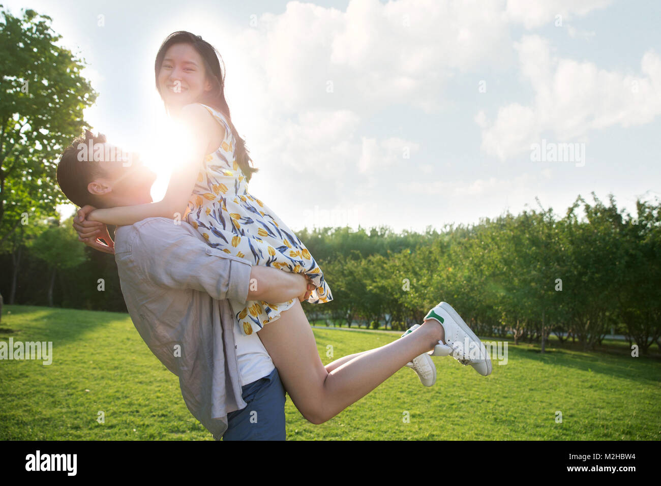 Happy lovers play outdoors Stock Photo - Alamy