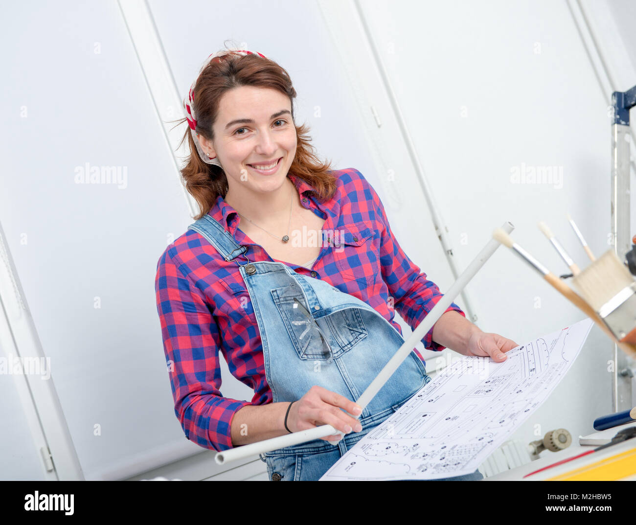 young smiling woman doing DIY work at home Stock Photo - Alamy