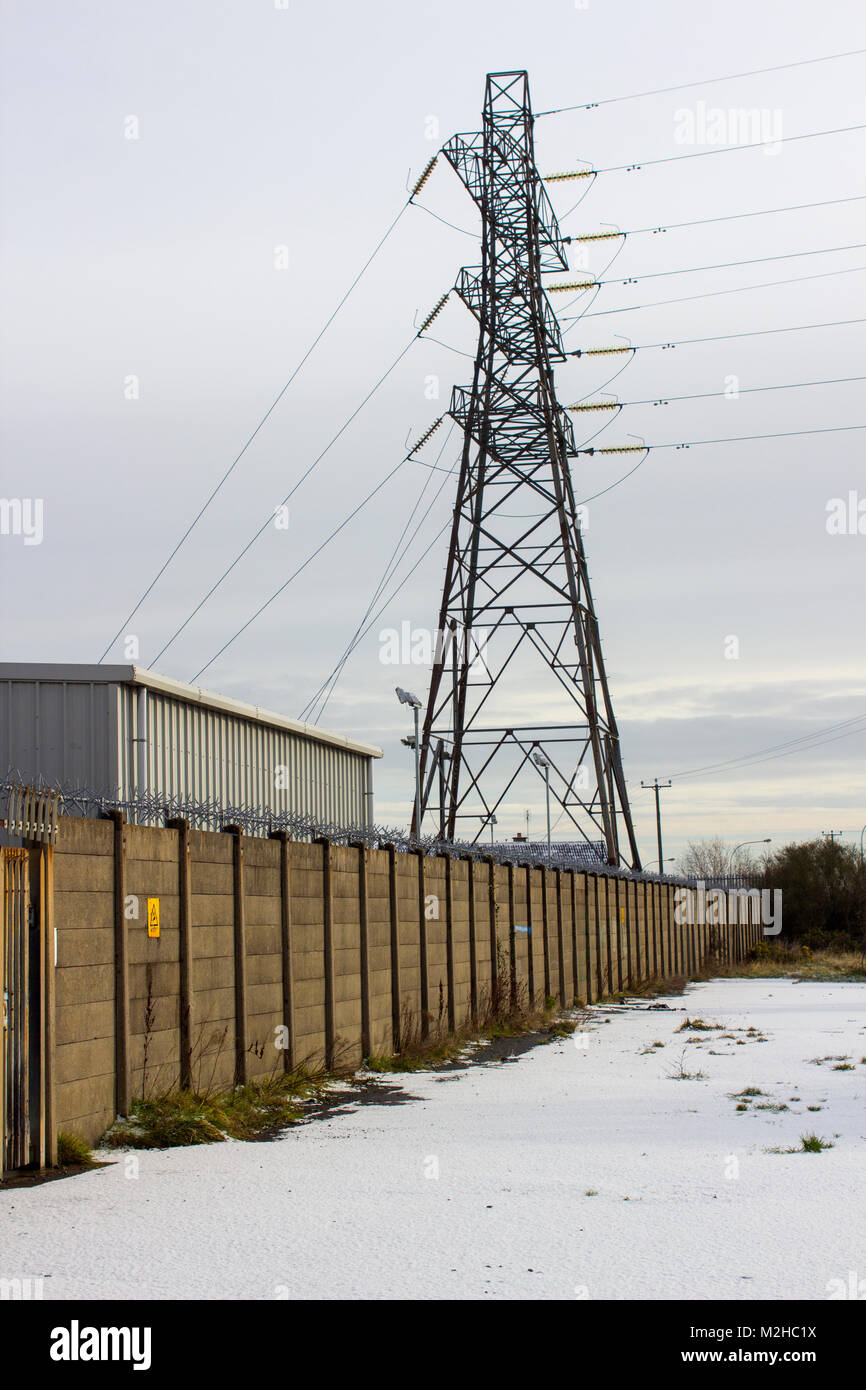 A tall steel electricity pylon on a large substation supply point in ...