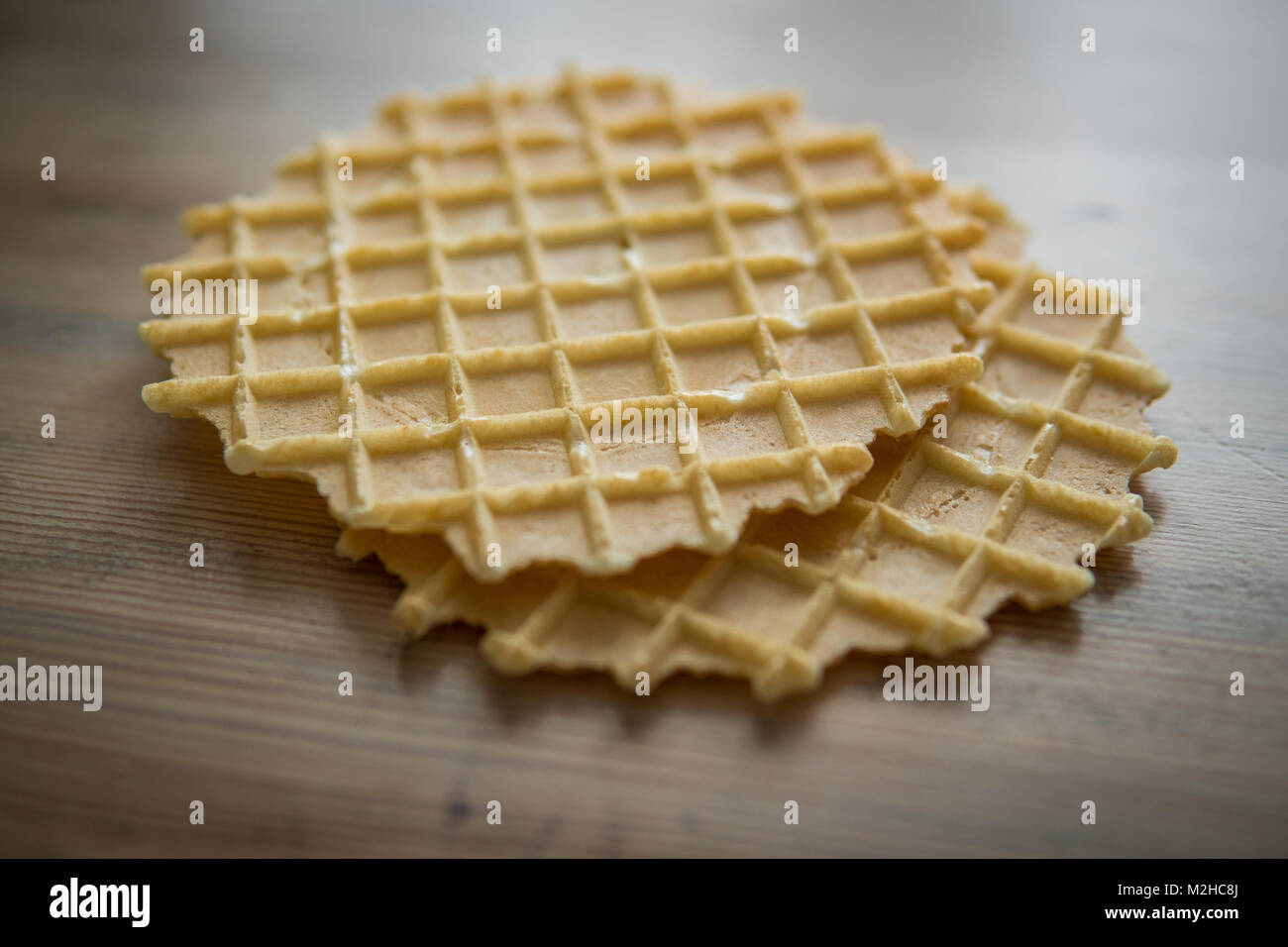 round waffle lying on an vintage wooden table Stock Photo - Alamy