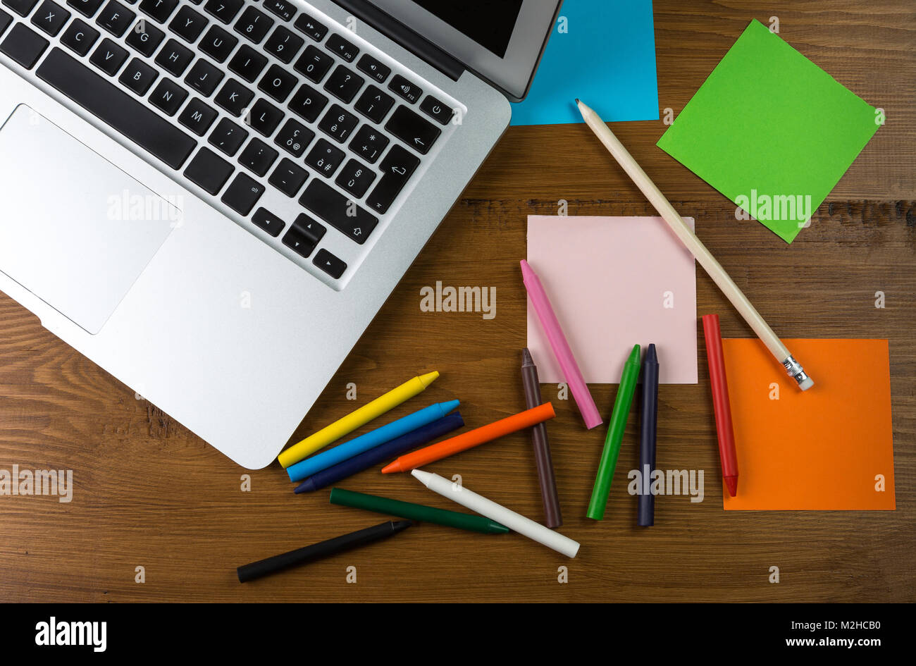 Colored blank post-it with office supplies on wooden table. Top view ...
