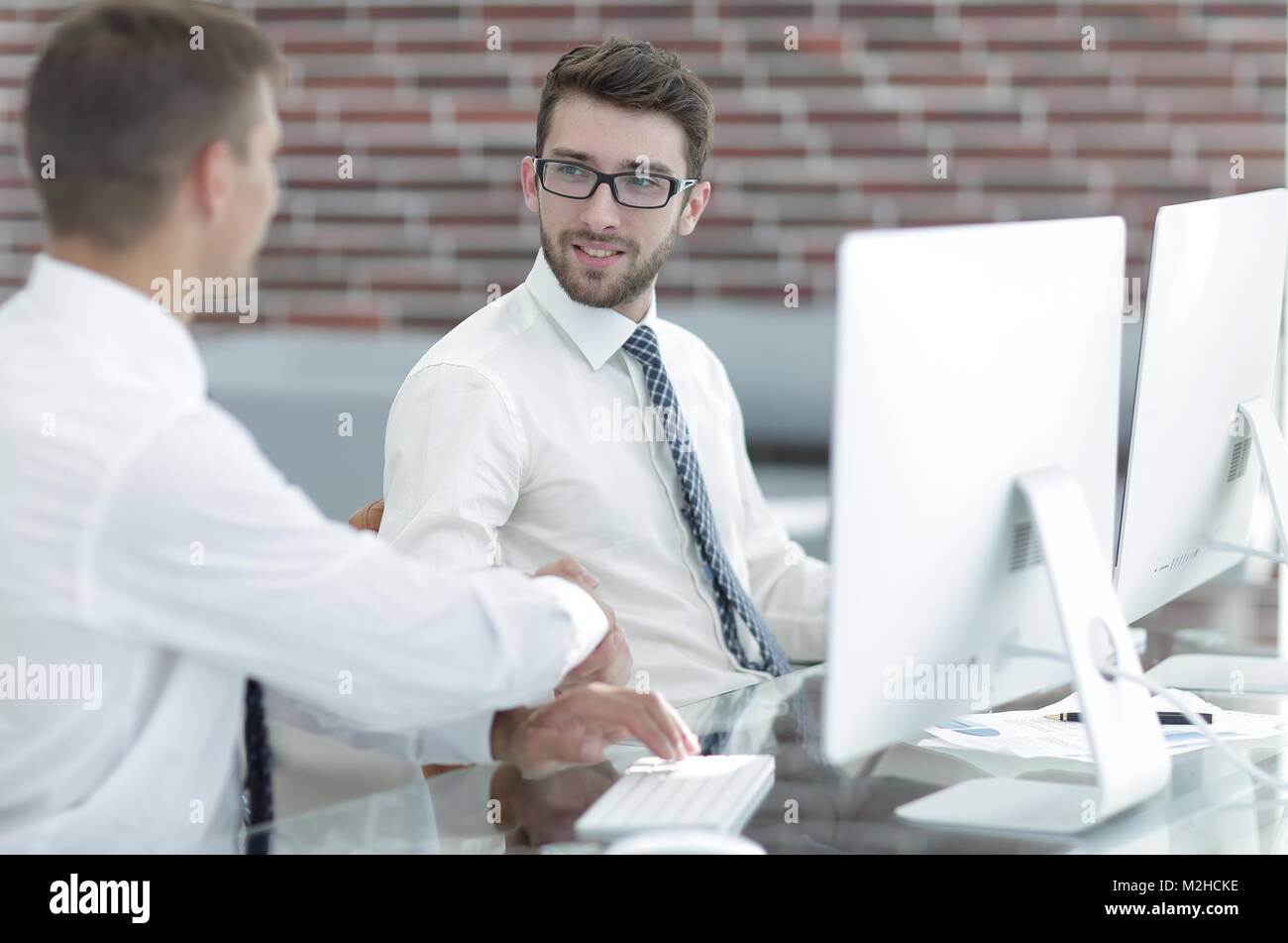 handshake of the employees at the Desk Stock Photo - Alamy