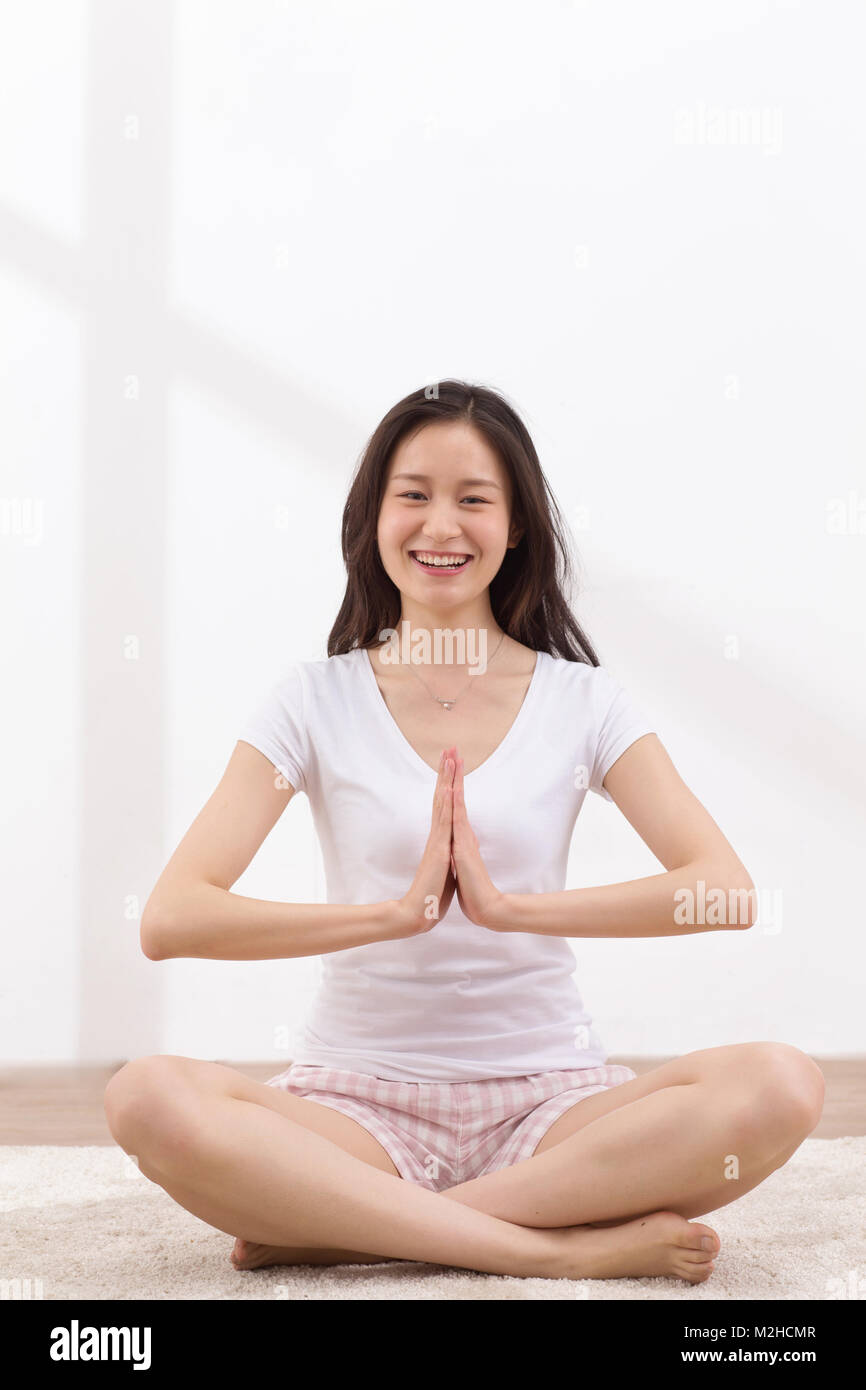 Young women practice yoga Stock Photo - Alamy