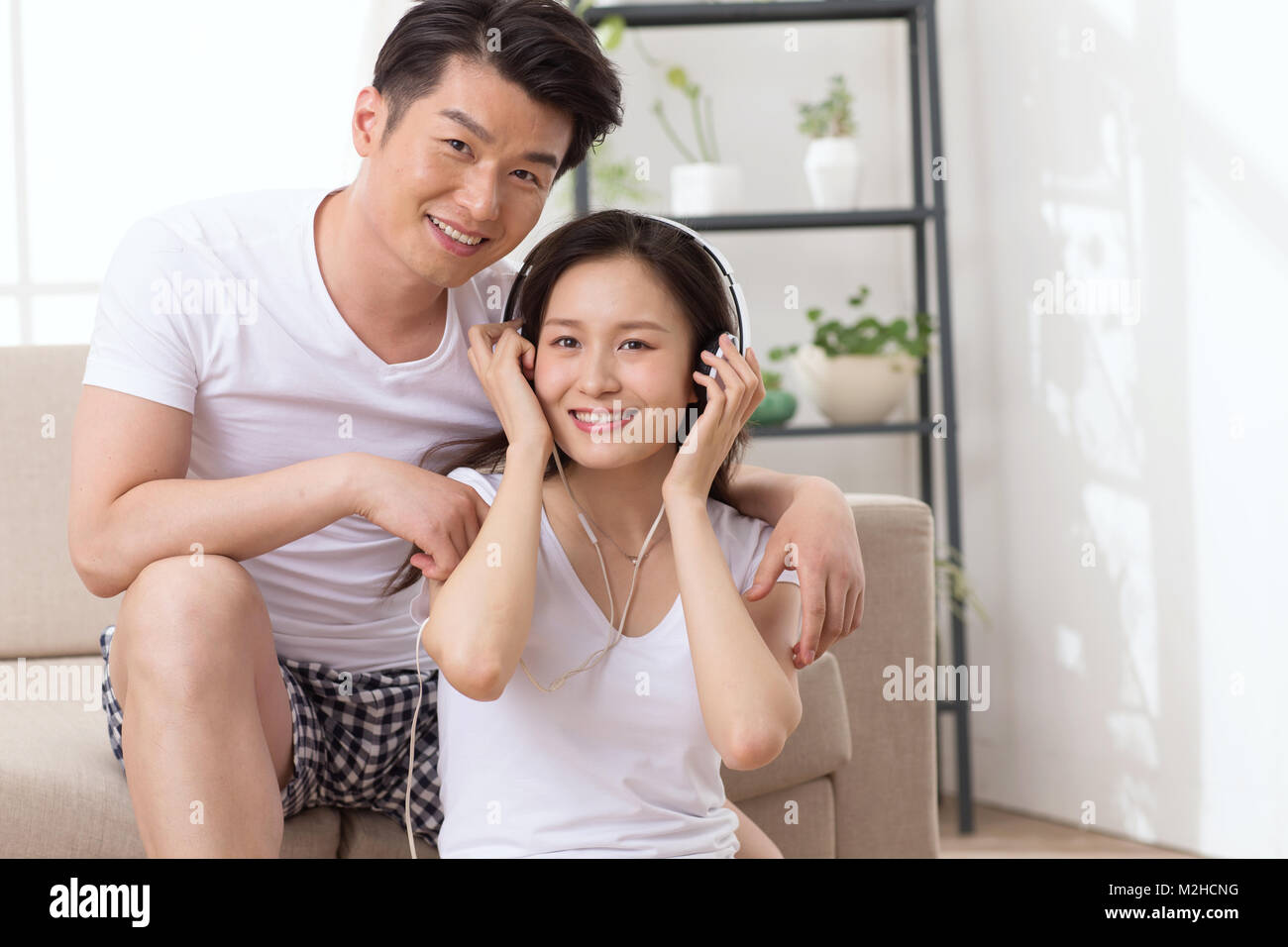 Romantic lovers listen to music Stock Photo - Alamy
