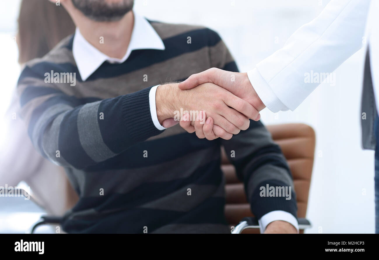 handshake between colleagues in the workplace Stock Photo - Alamy