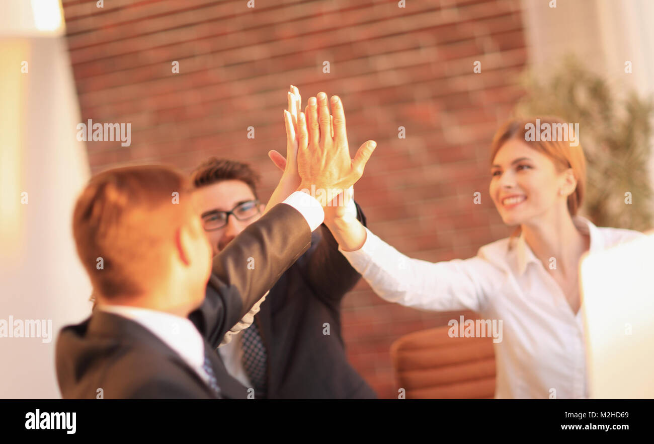 successful business team giving each other a high five Stock Photo - Alamy