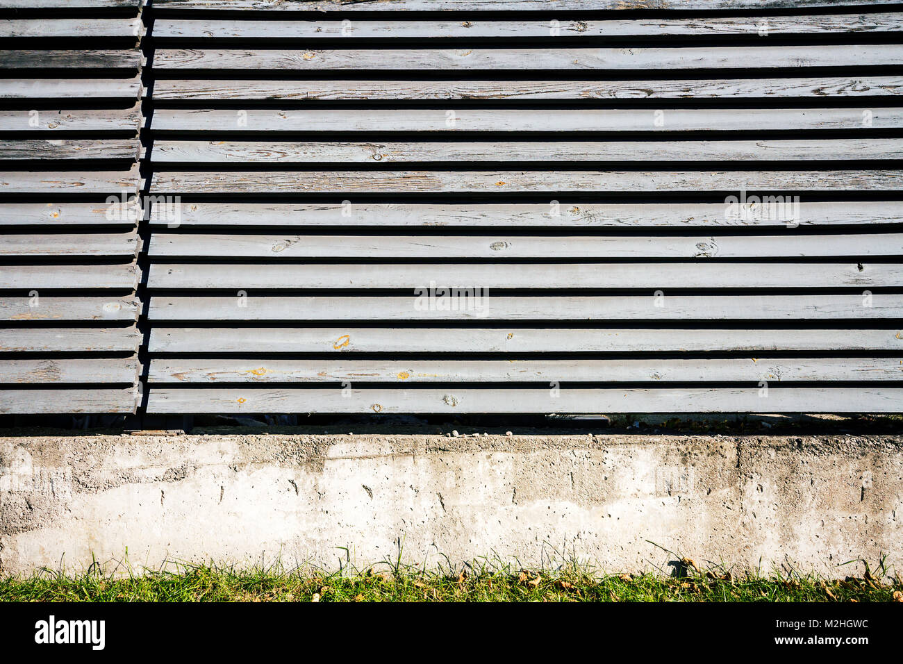 Blue wood plank fence on a concrete base Stock Photo - Alamy