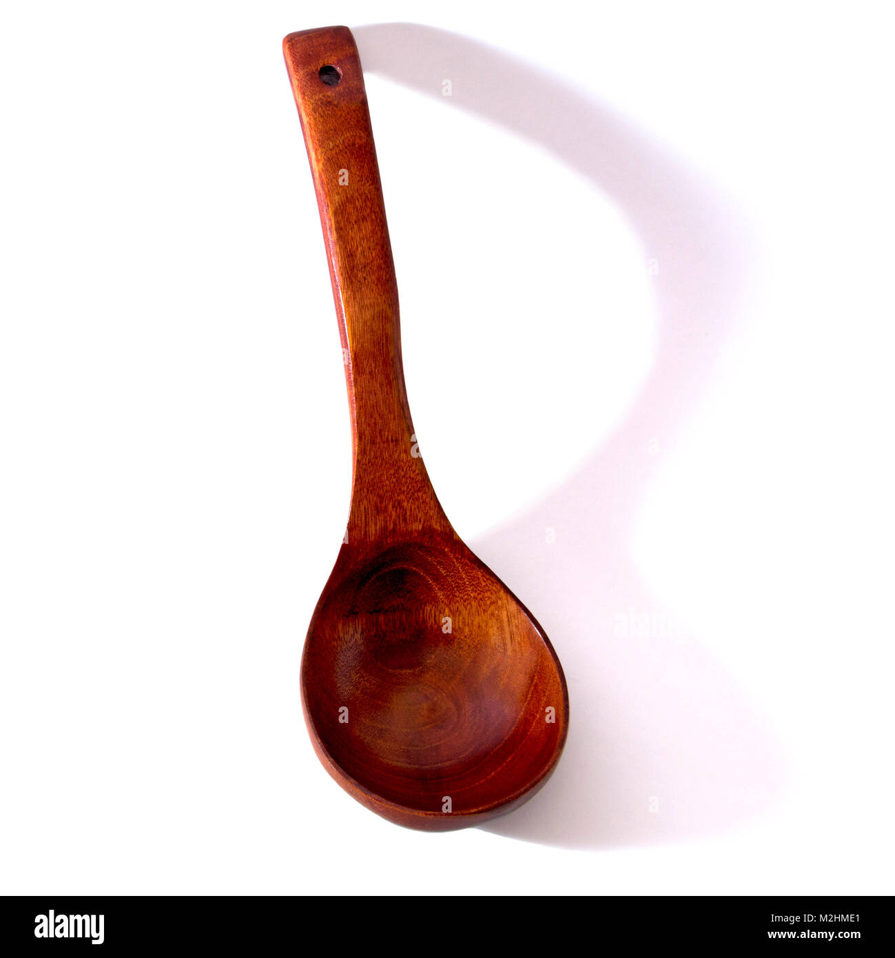 Wooden brown spoon on a white background it is isolated. Soft light ...