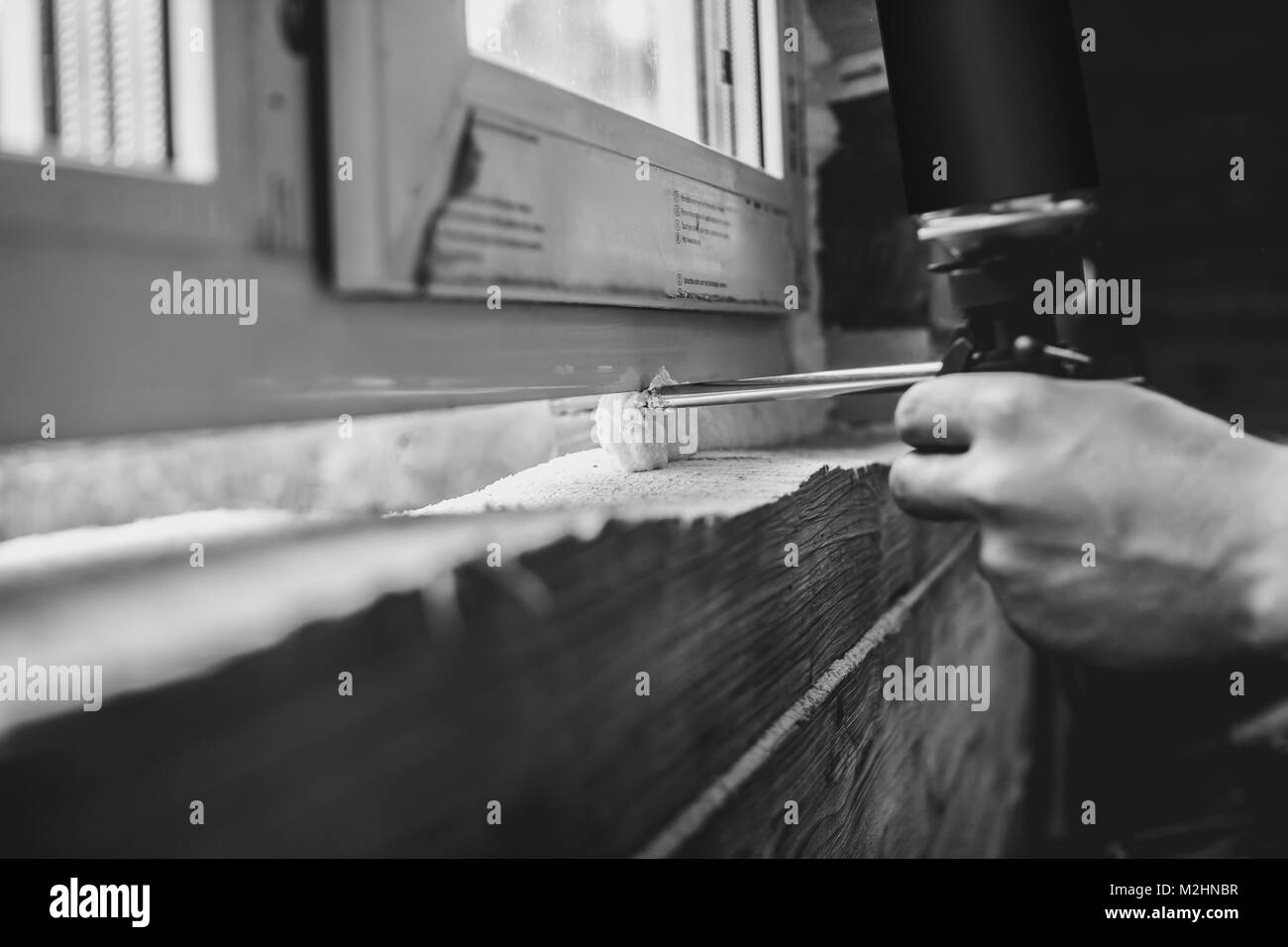 Applying polyurethane foam. Detailed view on process of installing a ...