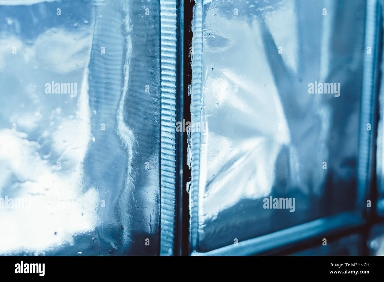 Wall of transparant glass tiles serving as colorful window wallpaper ...