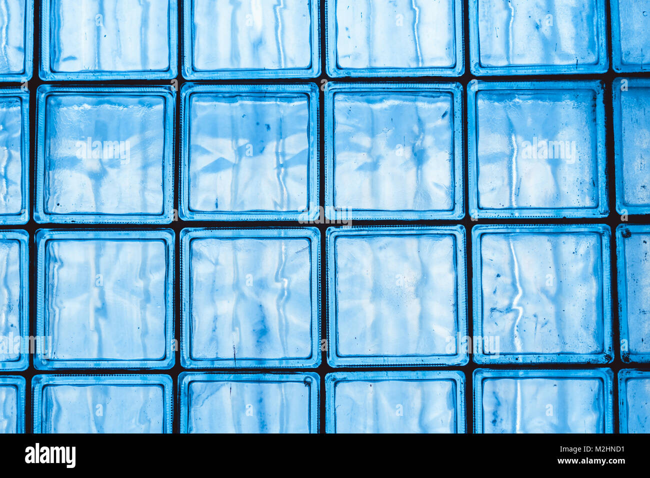 Wall of transparant glass tiles serving as colorful window wallpaper ...