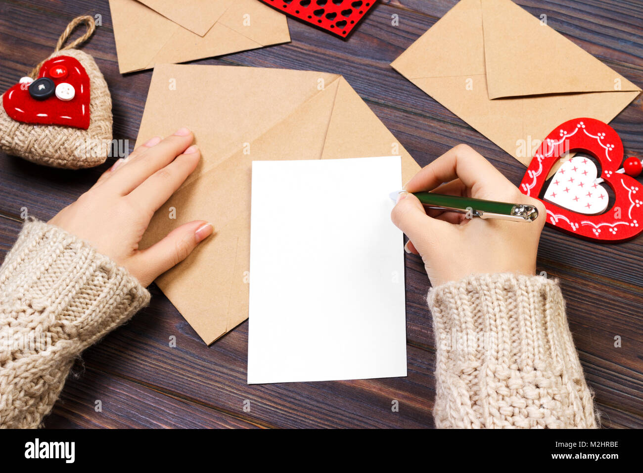 Woman writing love letter or romantic poem for Valentines day, top view ...