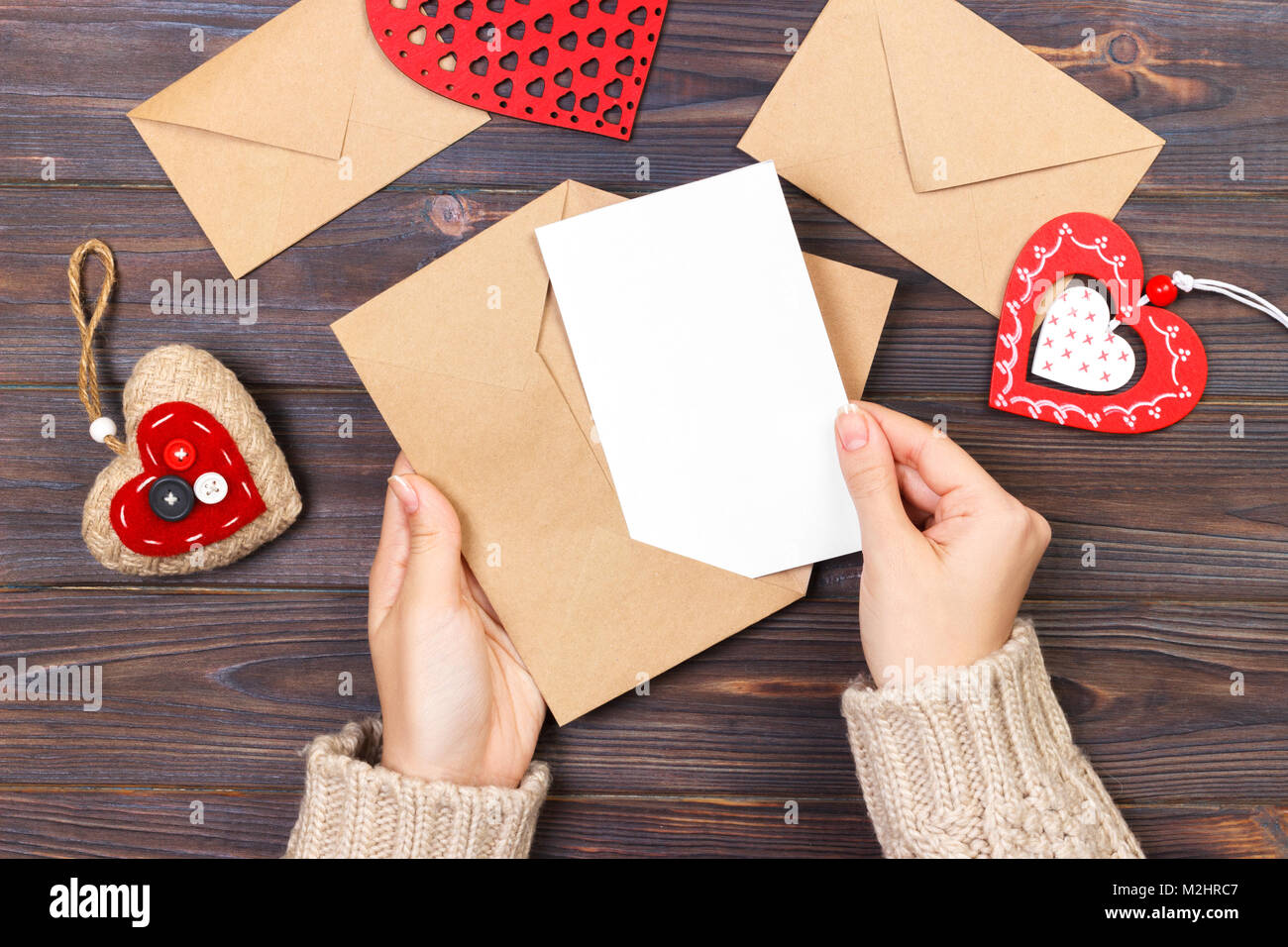 Top view. Hand of girl writing love letter on Saint Valentines Day ...