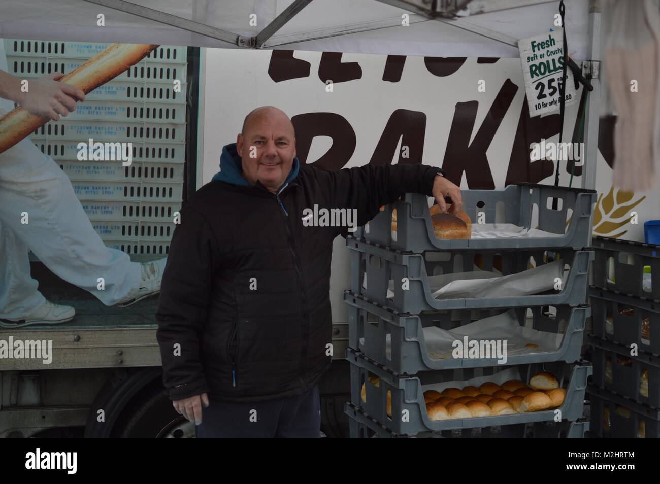A friendly baker at a market stall Stock Photo - Alamy