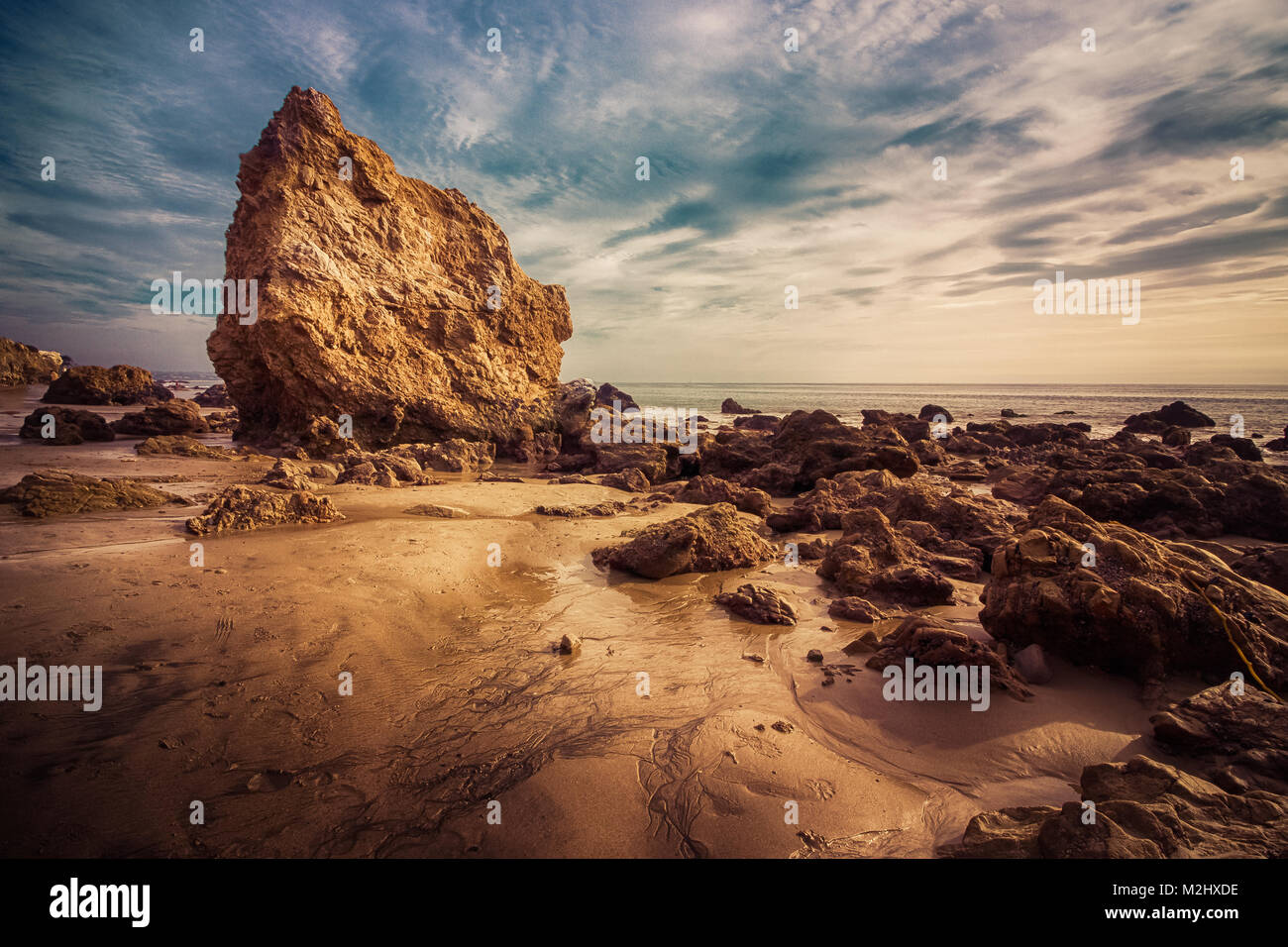 Beautiful tide pools and rock formations on a sunny day with clouds in ...