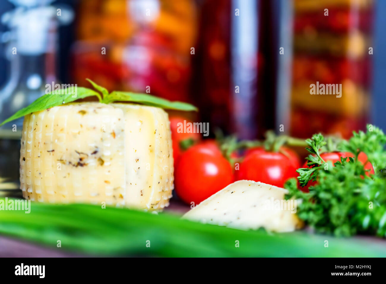Rustic cheese with herbs and vegetables Stock Photo - Alamy