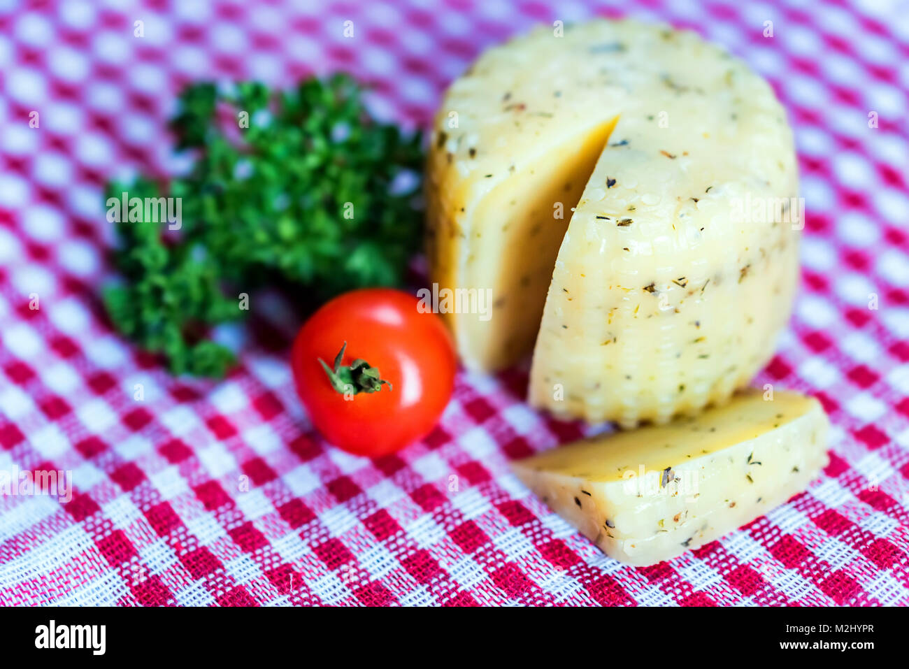 Rustic cheese with herbs and tomatoes Stock Photo - Alamy